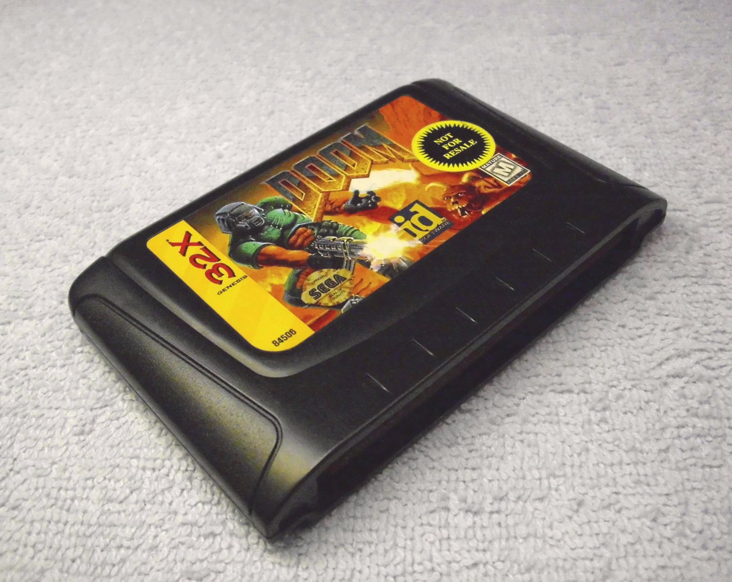 Doom 32x, by id, game cartridge with manual, for Sega 32x platform Genesis, 1994.