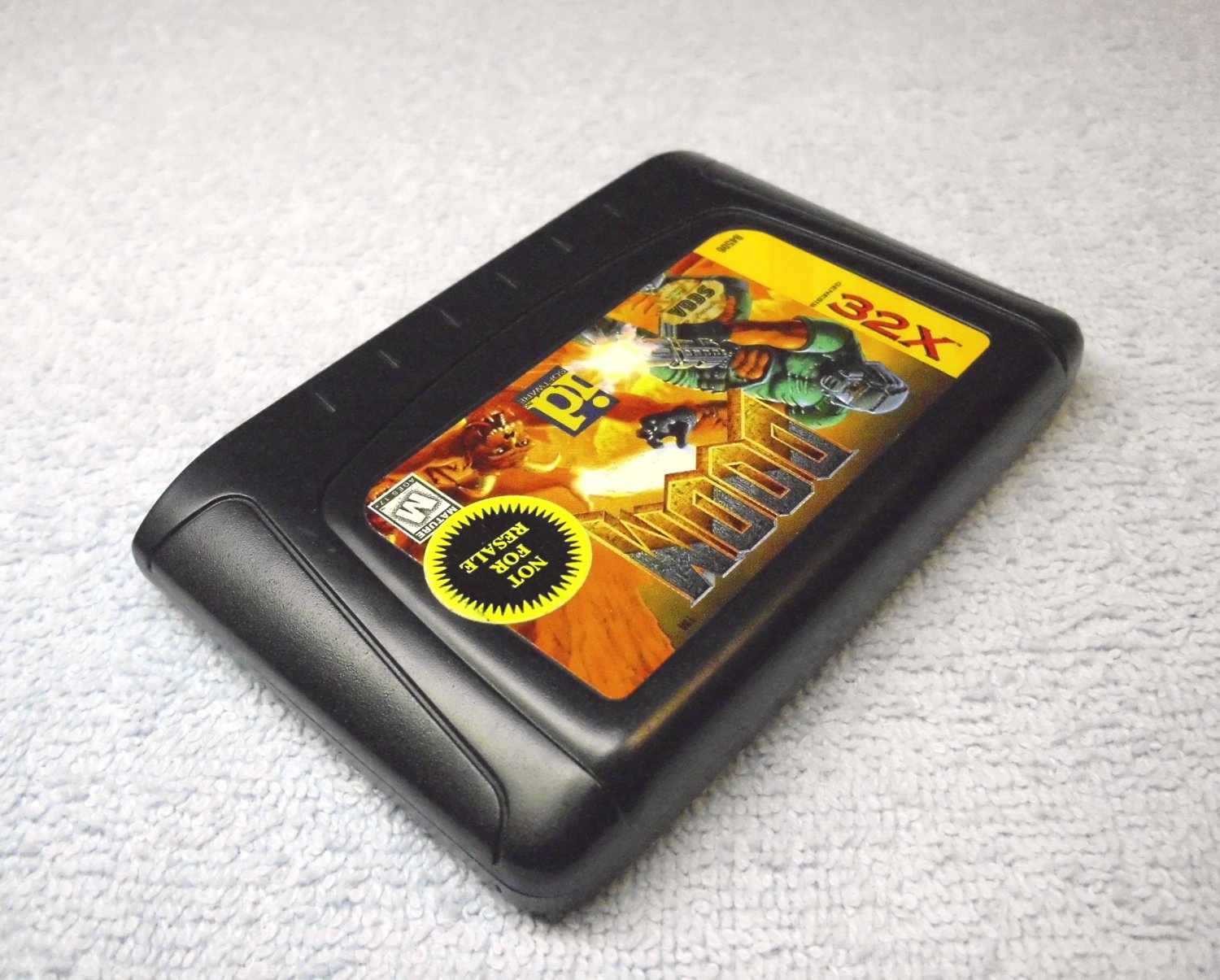 Doom 32x, by id, game cartridge with manual, for Sega 32x platform Genesis, 1994.