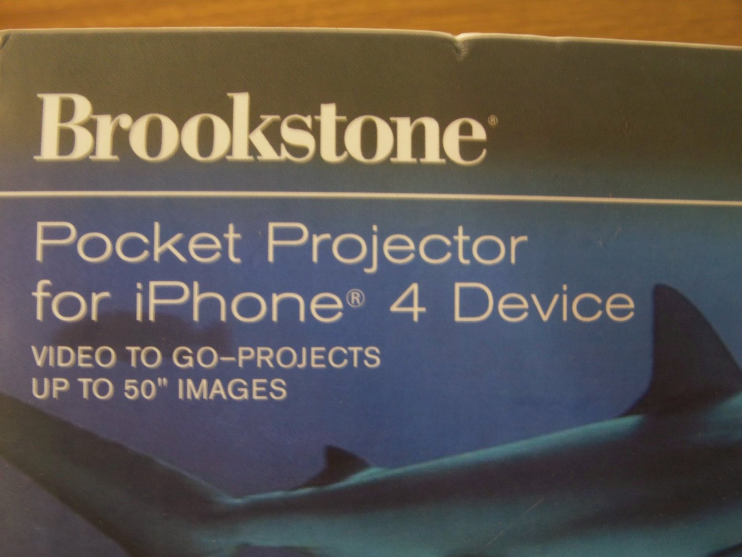 Brookstone Pocket Projector for iPhone 4 Device Projects up to 50 ...