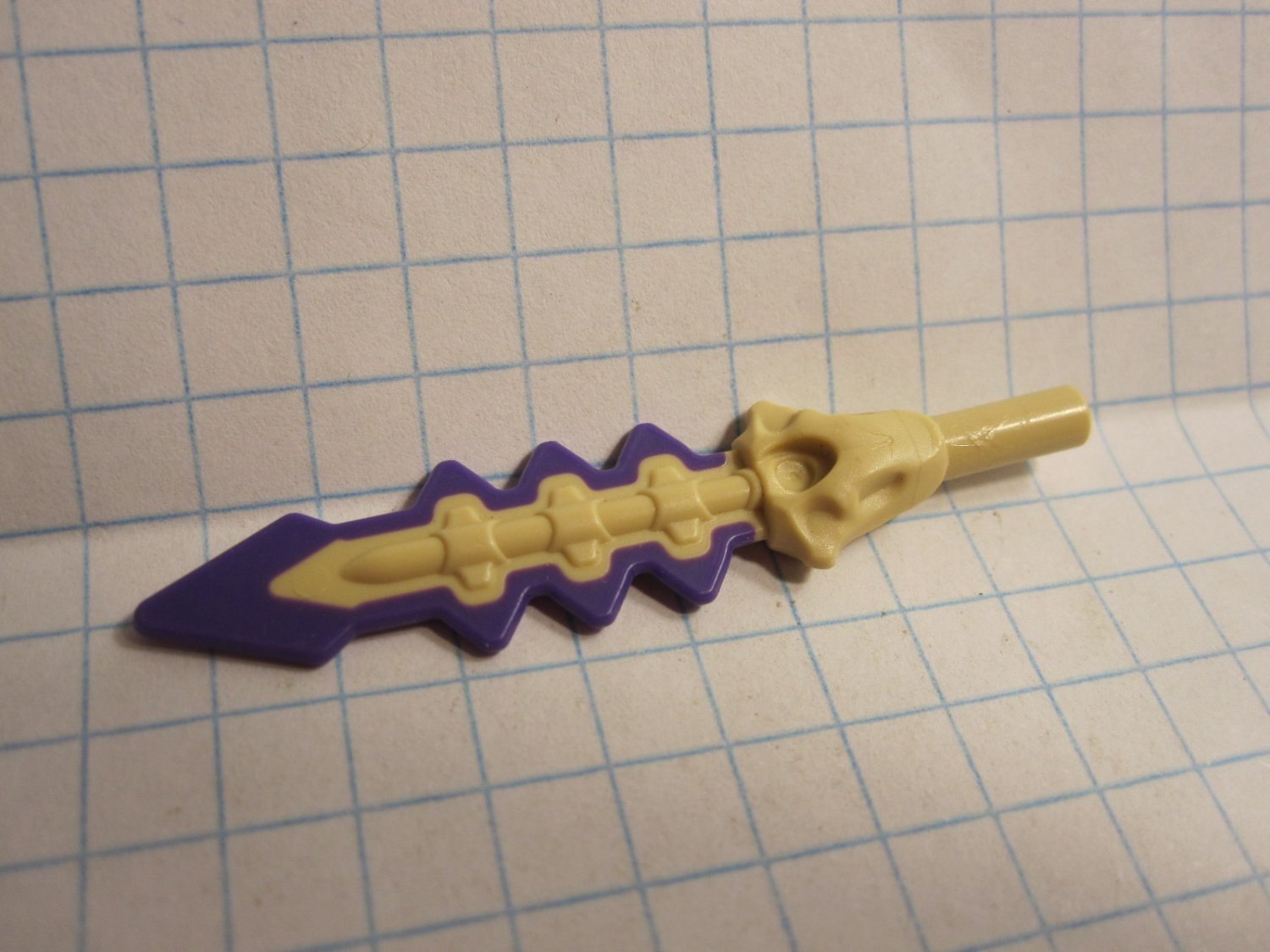 Lego Weapon part #18957pb01: Tan/Dark Purple- Serrated Sword w/ Skull Hilt