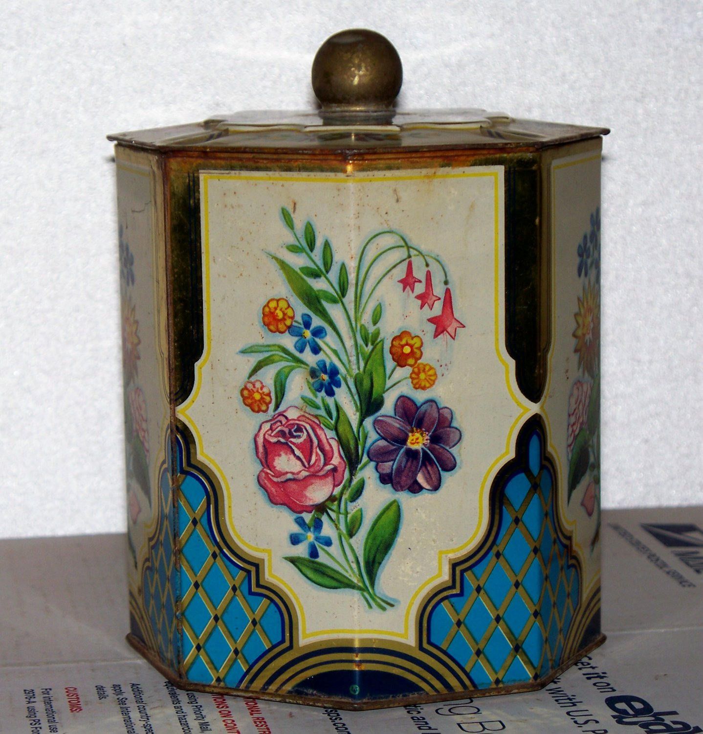 8 sided tin made in Western Germany with lid used and empty unknown maker