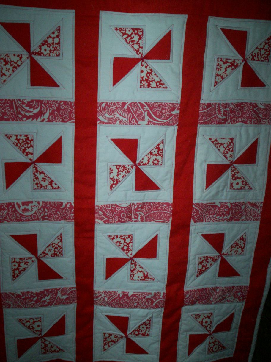 red pinwheel quilt handcrafted 39 inches by 50 inches handmade