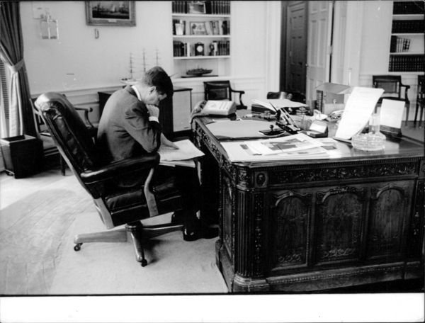 John F. Kennedy reading. - 8x10 photo