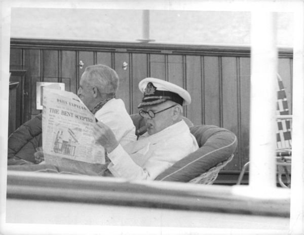 Winston Churchill while reading newspaper in 1958. - 8x10 photo
