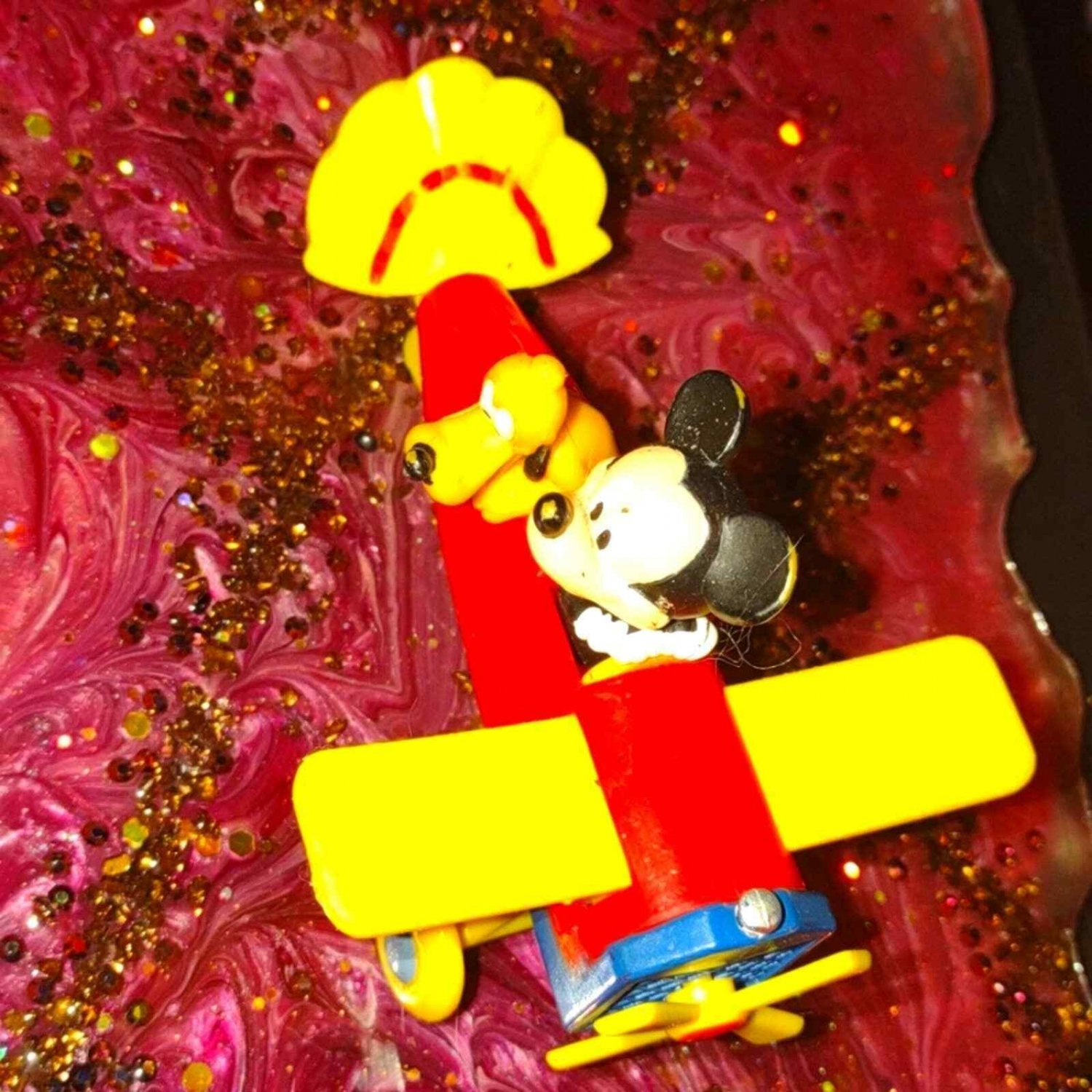 Mickey and Goofy flying high in their plane
