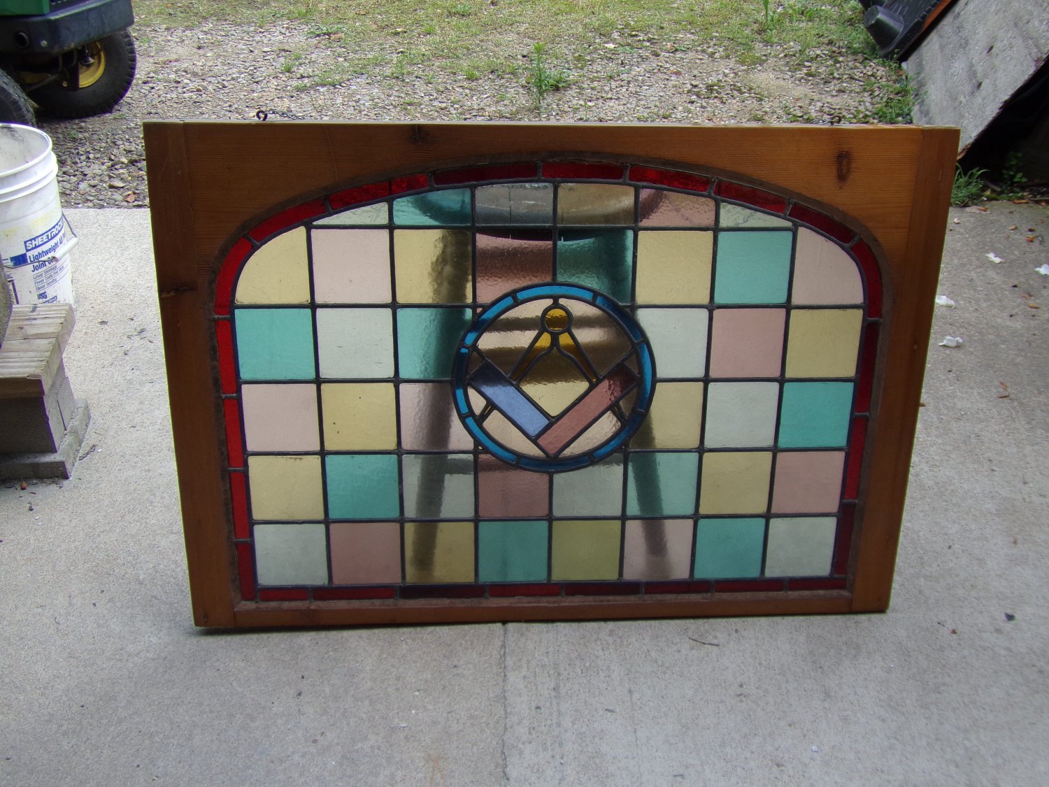 Antique stained glass window with Masonic emblem