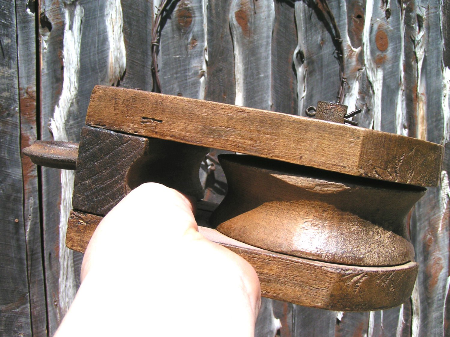 Old wooden rope pulley with wood wheel ec