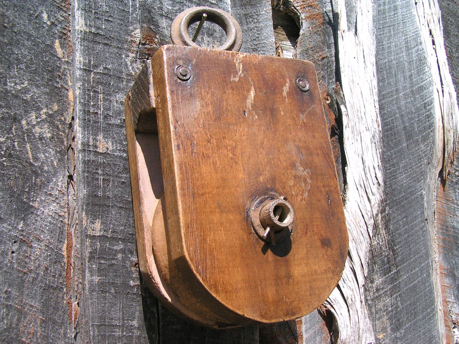 Old wooden rope pulley with wood wheel ec