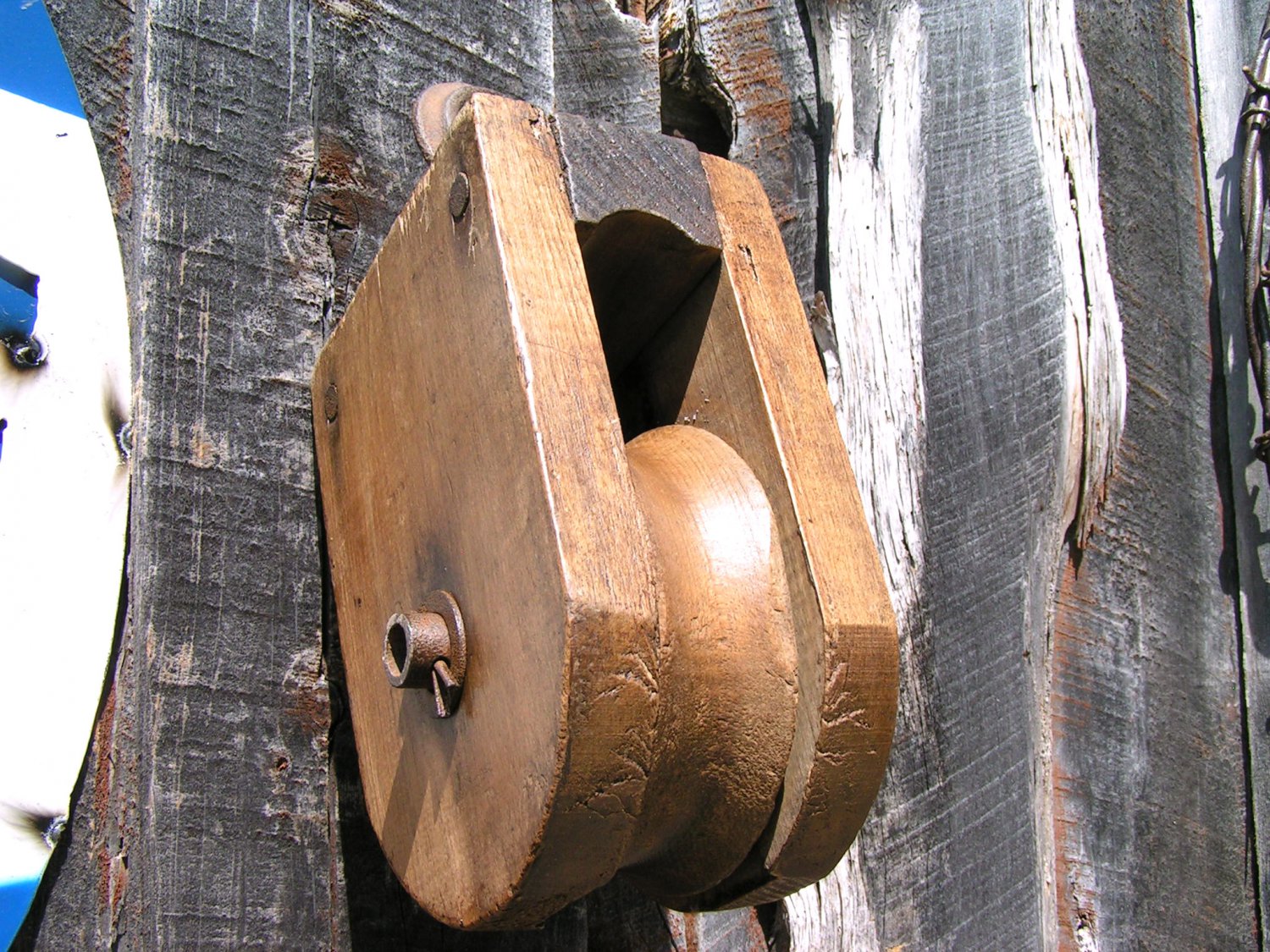 Old wooden rope pulley with wood wheel ec