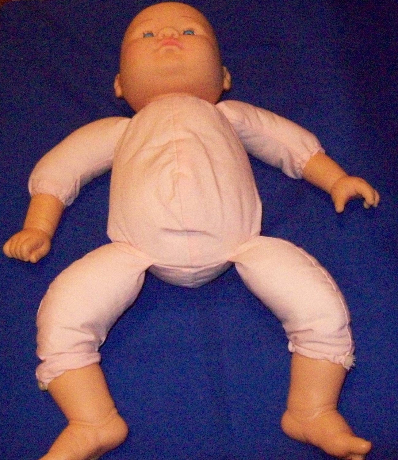 Baby boy doll, vinyl head, soft cloth body with flexible arms and legs.