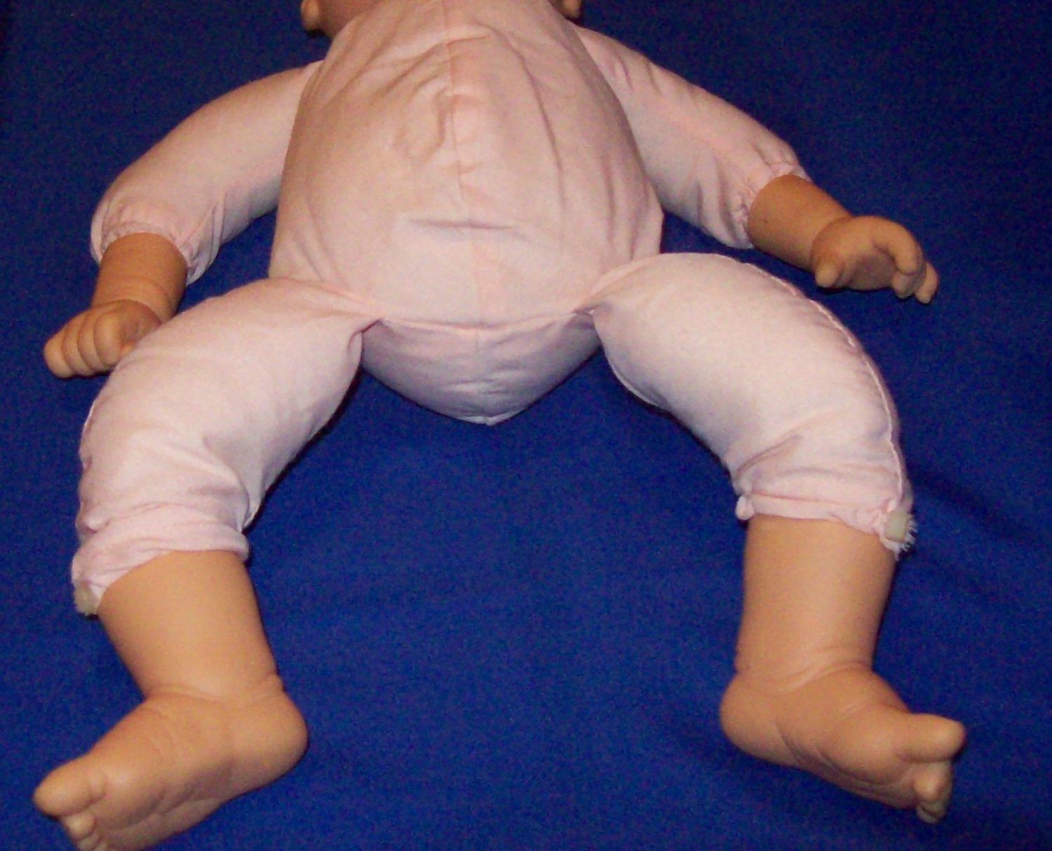 Baby boy doll, vinyl head, soft cloth body with flexible arms and legs.