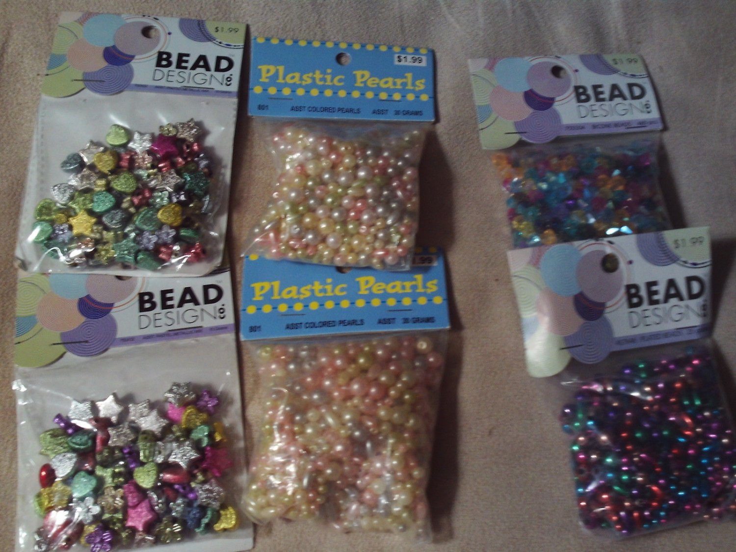 6 Packages of Plastic Beads Assortment and shapes.